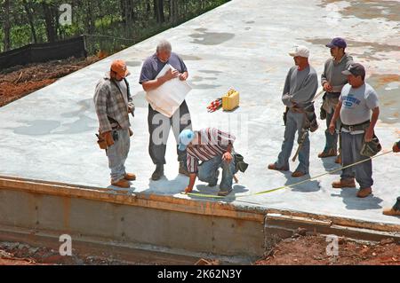 Crew getting layout instructions to put up wood walls on new home ...