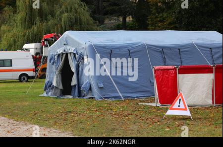 camp equipped with a blue tent and warning signs and the text in ...