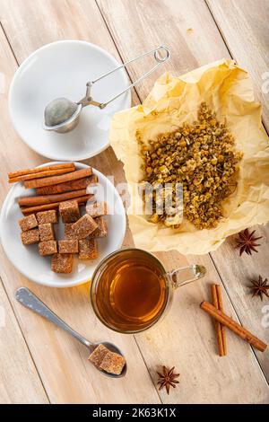 Hot chamomile tea made of wild flowers with a mesh ball tea infuser ...