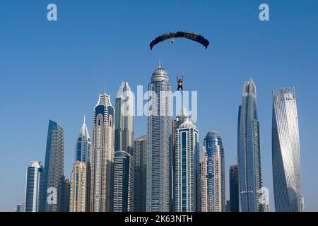 Dubai, United Arab Emirates - tandem skydivers prepare to land back to ...