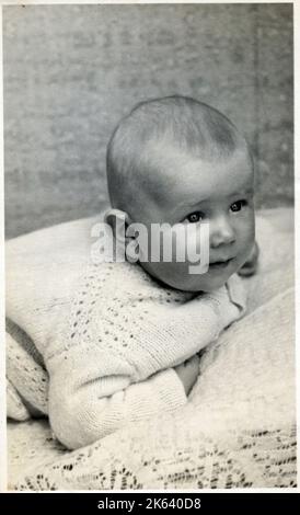 little baby boy 7 months old sitting on the fall leaves, walking in the ...