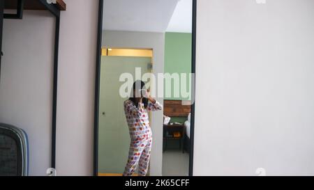 Manado - Indonesia, October 8, 2022, a beautiful girl takes a picture ...