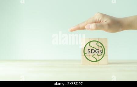 SDG or Sustainable development goals concept. Human hand stacking ...