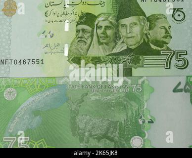 Pakistani new 75 rupees banknote with a Pakistan passport on white ...