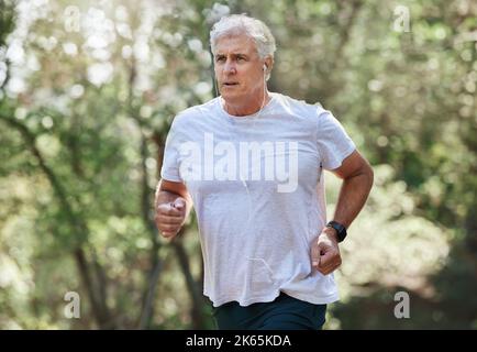 Running to maintain a healthy heart and body. a mature man running ...