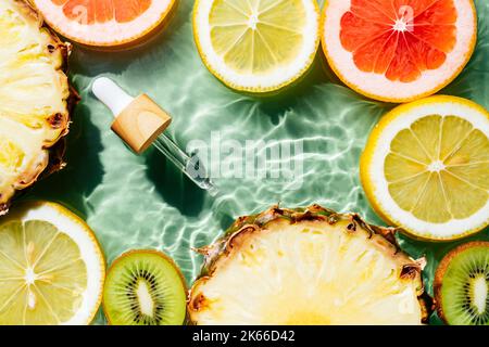 Facial pipette serum, whey beauty product near fruit citrus lemon and ...