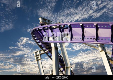 Attraction roller-coaster (switchback) on the background of the cloudy ...