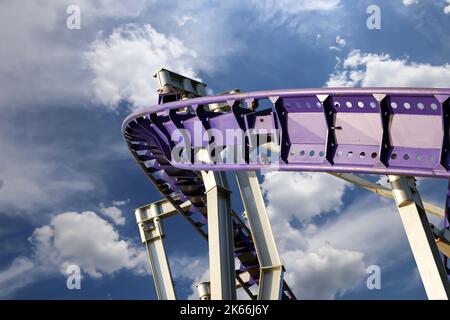 Attraction roller-coaster (switchback) on the background of the cloudy ...