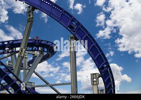 Attraction roller-coaster (switchback) on the background of the cloudy ...