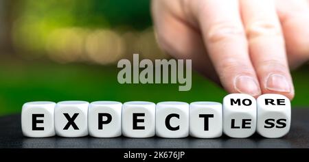 Less is more concept. Hand turns dice and changes the 'smaller symbol ...