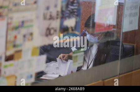 Police officers investigate at the clinic of Doctor Wong Ping-leung in ...