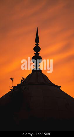 A vertical shot of a spire top silhouette against sky at sunset Stock ...