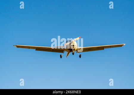 Single-propeller plane landing from a nose-down view centred in the ...