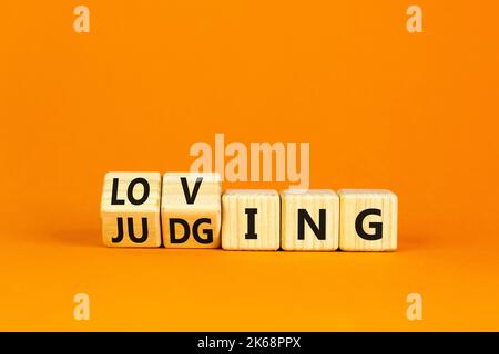 Loving or judging symbol. Concept words Loving or Judging on wooden ...