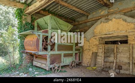 vintage winnowing machine shaded under a building canopy Stock Photo ...