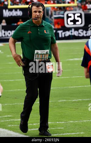 Miami head coach Mario Cristobal, center, runs onto the field before an ...