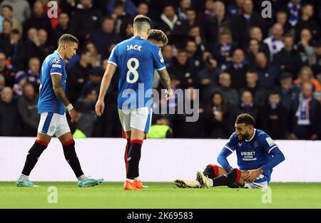 Rangers' Connor Goldson picks up an injury as he challenges Liverpool's ...