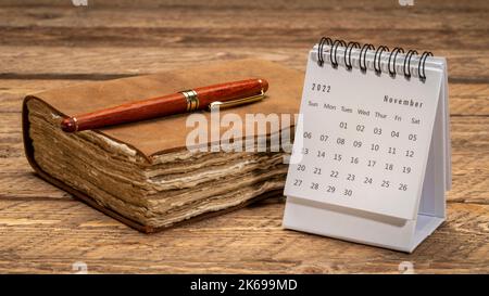 November 2022 - small spiral desktop calendar against textured handmade ...