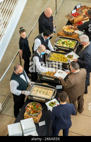 Diners line up at a gourmet dinner buffet serving line in Southern ...