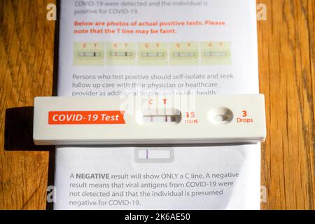 Two lines on a COVI9-19 rapid test indicate a positive result and the ...