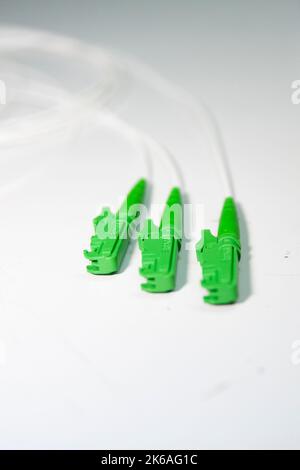 Green fiber optic cable connector on white background Stock Photo - Alamy