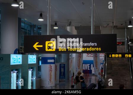 Sign at Alicante Airport directing passengers to bus area, for shuttle ...