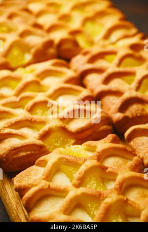 puff pastry mini pies with with pear and lime jam filling on a white ...