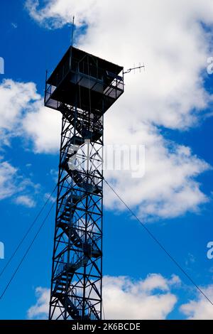 Watchtower for fire surveillance in silhouette on hilltop overlooking ...