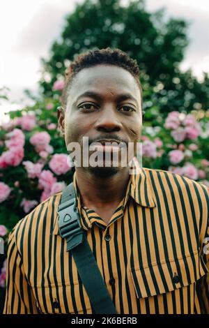 Adult man in striped t-shirt screaming and rubbing temples because of ...
