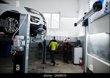 Auto mechanic sets american SUV car for diagnostics and configuration ...