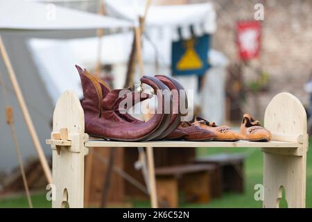 Jester shoes on a medieval market bench Stock Photo - Alamy