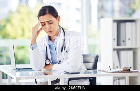Sad and gloomy young woman doctor in medical face mask, feeling upset ...