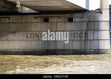 A close-up of the carved lettering underneath London Bridge bathed in ...