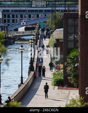People walk in the sun in London, Tuesday, June 23, 2026, as a heat ...