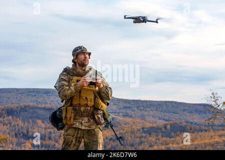 The mercenary launches a reconnaissance drone in a forest. Modern ...