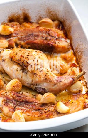 baked rabbit leg with garlic and bacon Stock Photo - Alamy