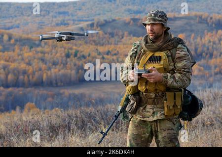 The mercenary launches a reconnaissance drone in a forest. Modern ...