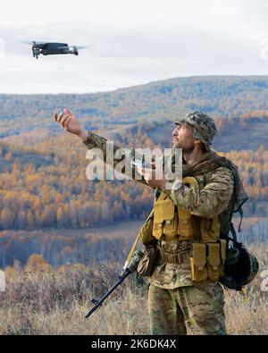 The mercenary launches a reconnaissance drone in a forest. Modern ...