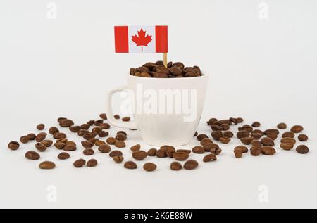 The flag of Canada sticks out of a cup with coins. Economy and business ...