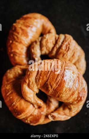 medialunas, argentinian sweet croissant over a black backdrop. copy ...
