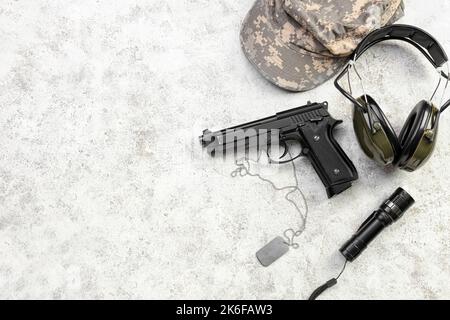 Military uniform, gun, flashlight and tag on light background Stock ...