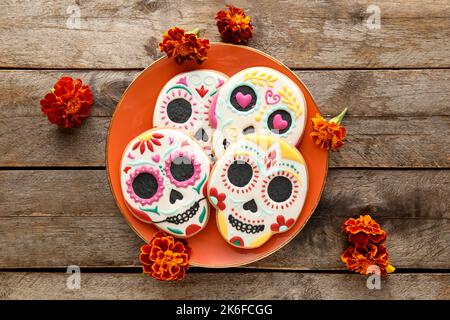 Skull shaped cookies and flowers on wooden background. El Dia de ...