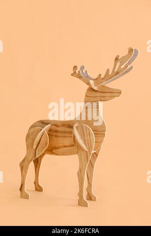 Decorative wooden reindeer on beige background Stock Photo - Alamy