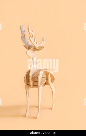 Decorative wooden reindeer on beige background Stock Photo - Alamy
