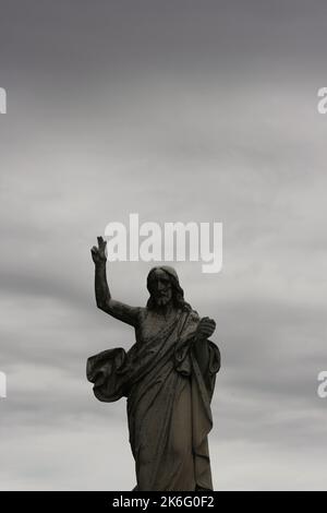 Stone statue of Jesus Christ pointing at His Sacred Heart on a ...