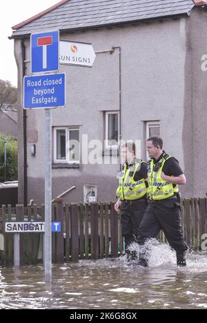 Residents walk through flood water in Retford in Nottinghamshire, after ...