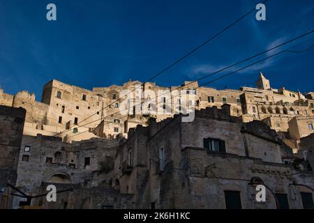 Townscape of the Sasso Caveoso district in Matera with a tourist with a ...