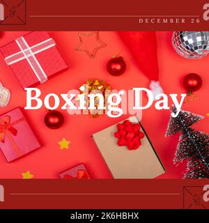 Composition of boxing day text over christmas decorations on red ...