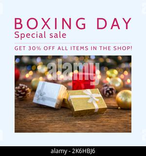 Composition of boxing day sales text over christmas decorations and ...