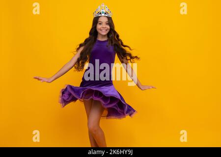 Movement windy dress. Little queen wearing golden crown. Teenage girl ...